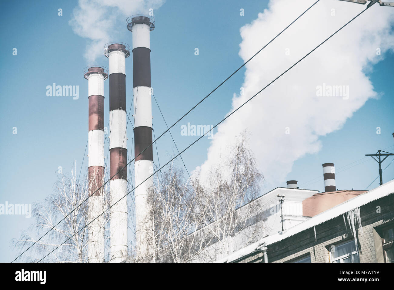 Three factory pipes smoke Stock Photo - Alamy
