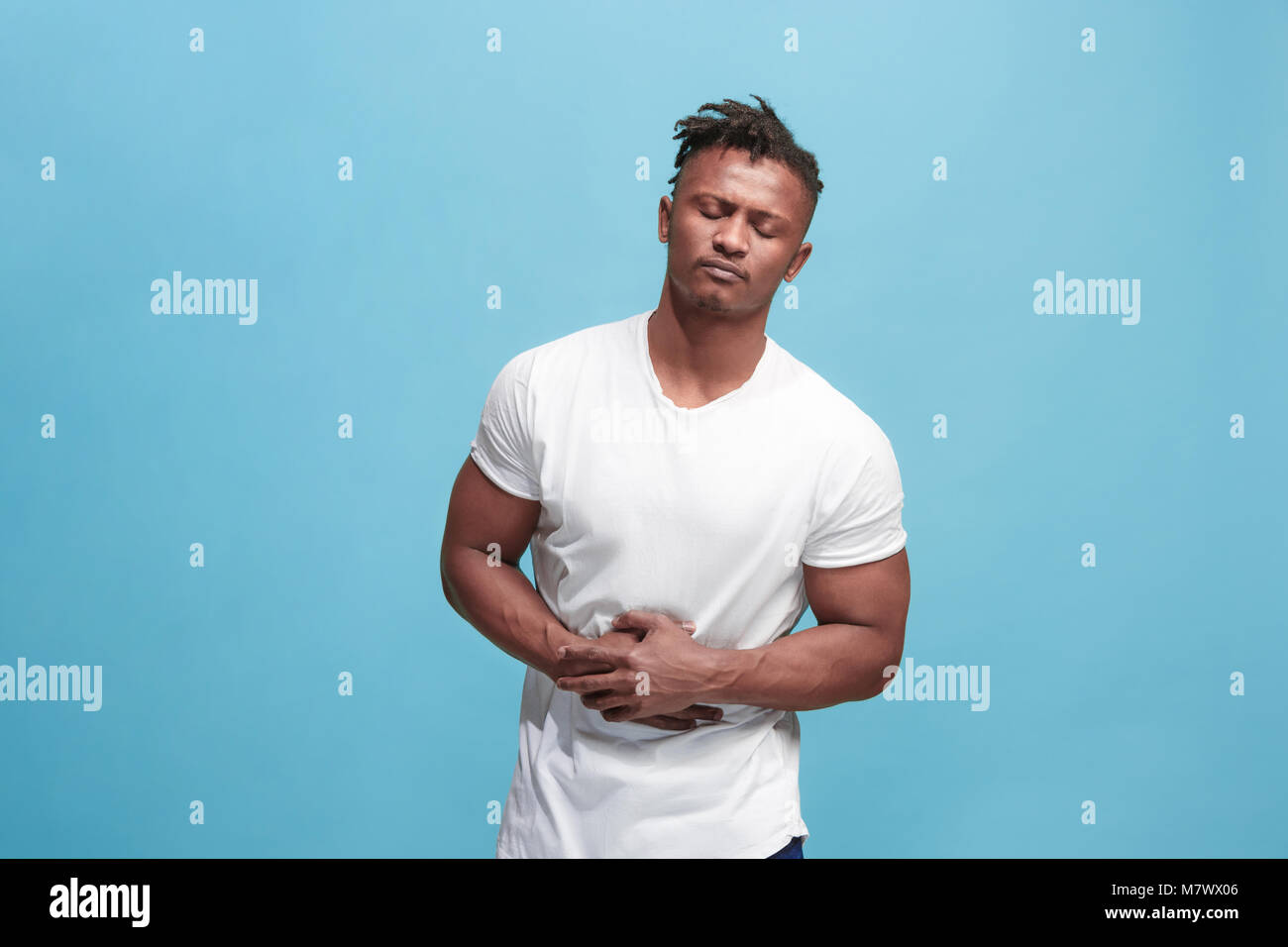 Man holding stomach in pain hi-res stock photography and images - Alamy