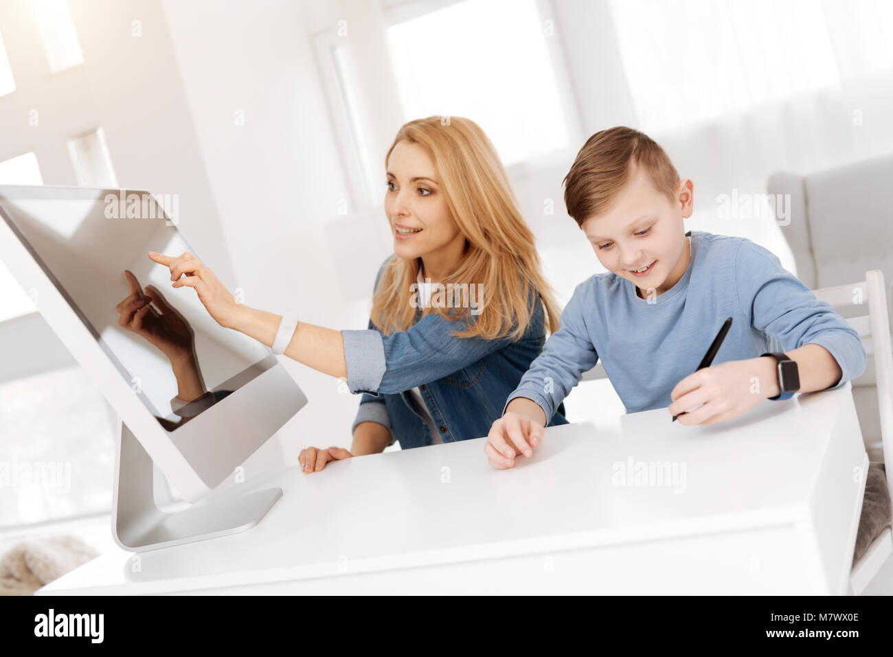 Pleasant beautiful woman pressing the sensory screen Stock Photo - Alamy