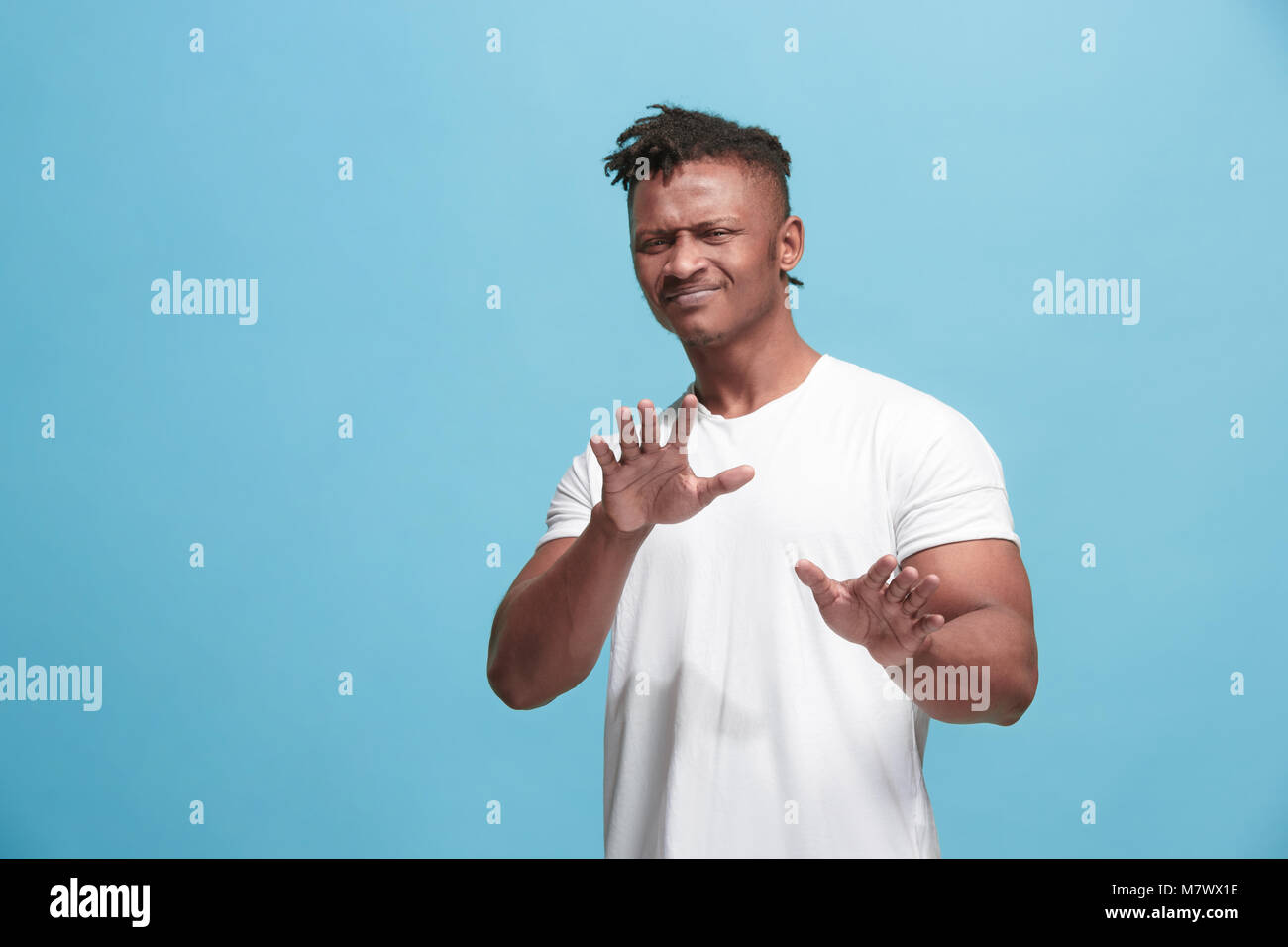 Young man with disgusted expression repulsing something, isolated on ...