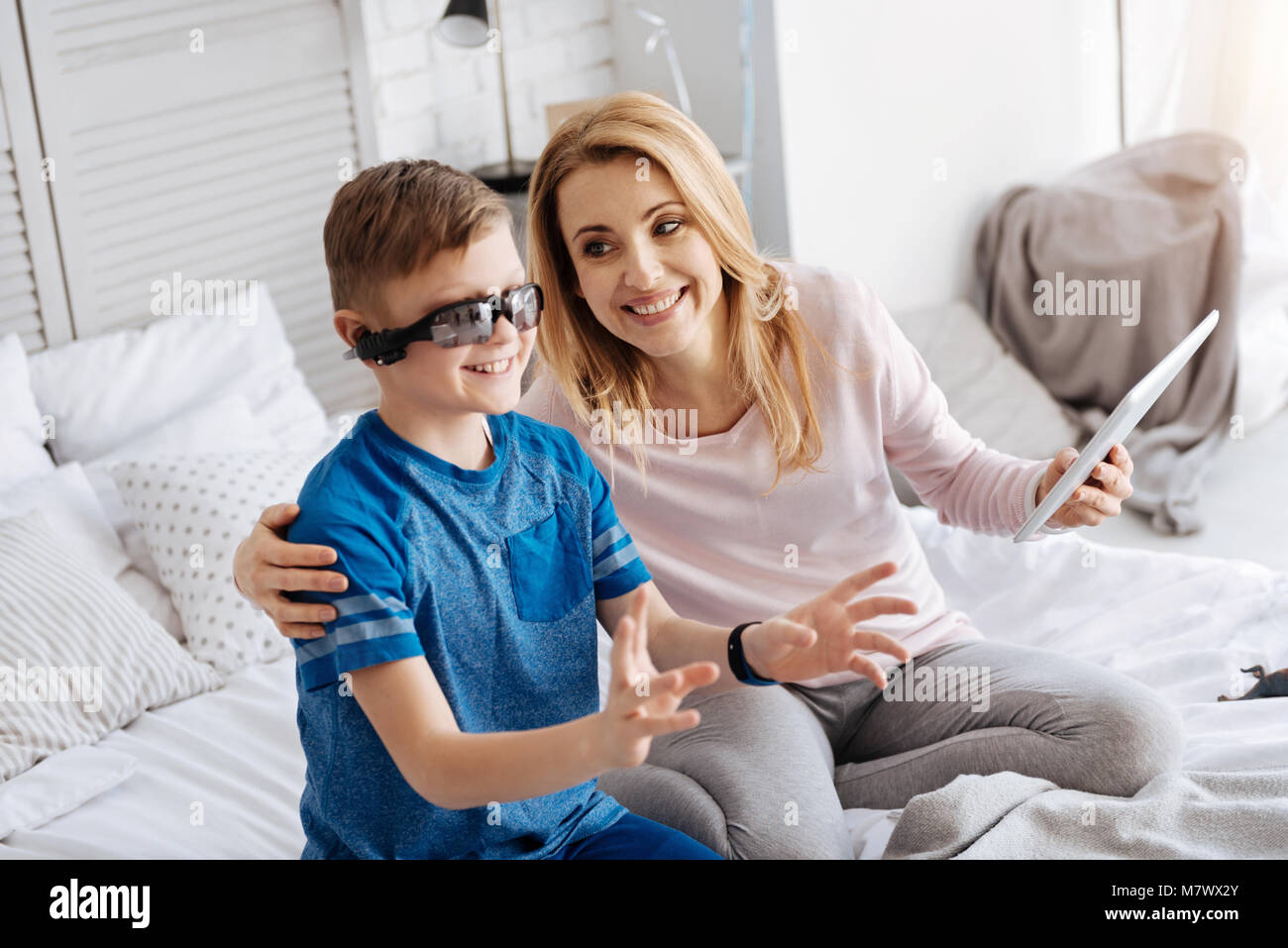 Happy positive mother hugging her son Stock Photo - Alamy