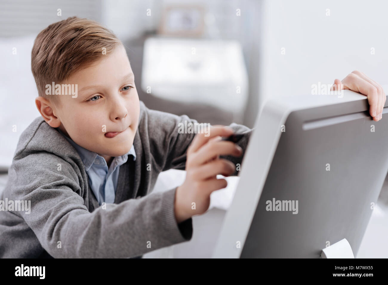 Nice smart boy focusing on the activity Stock Photo - Alamy