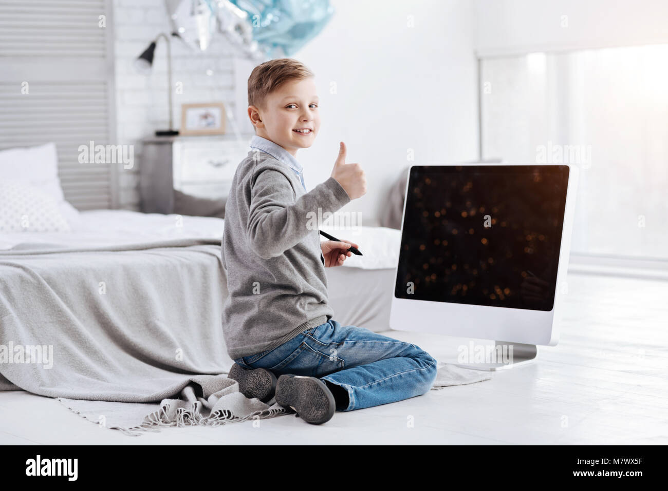 Happy cheerful boy showing OK sign Stock Photo - Alamy