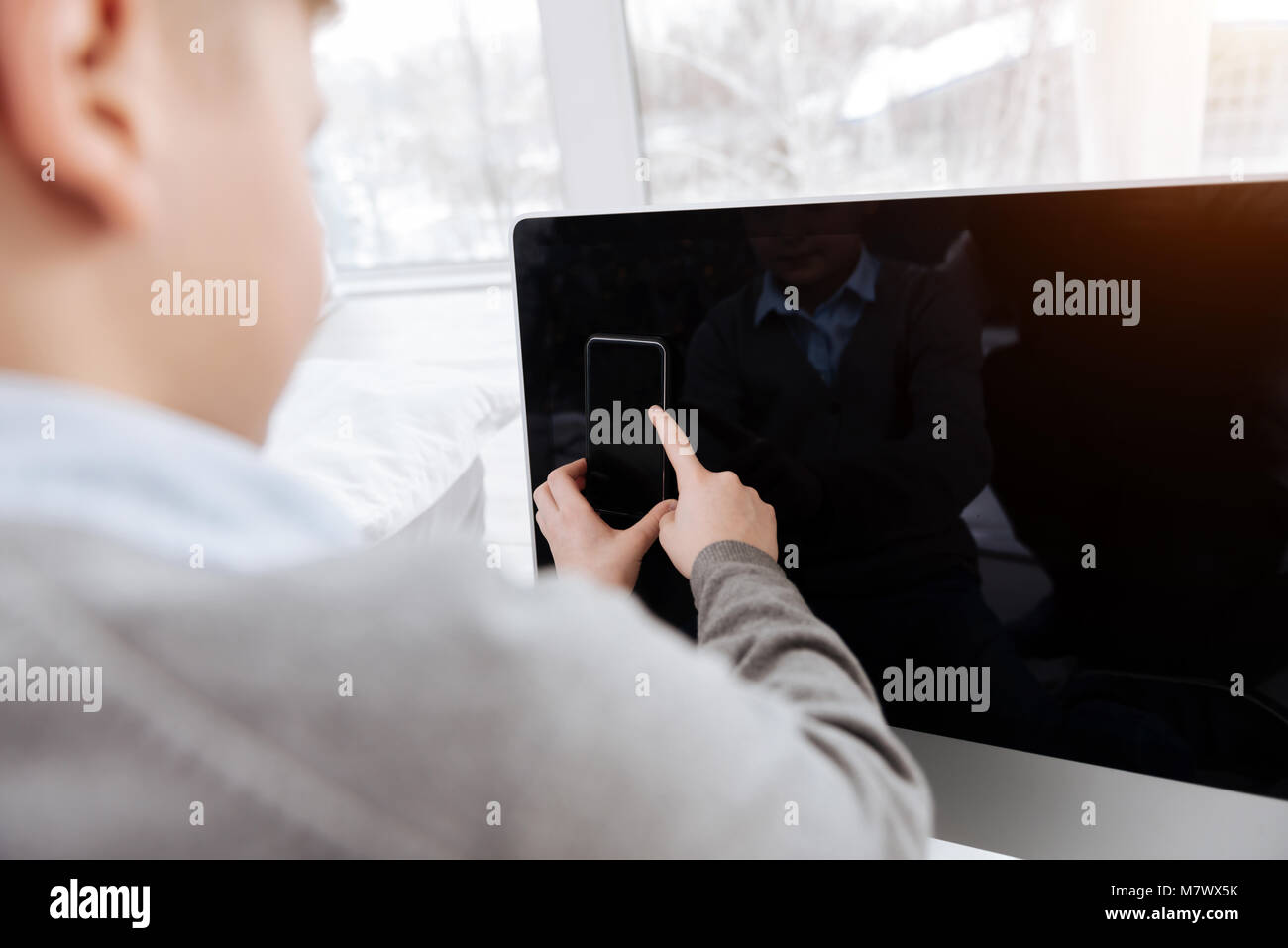 Smart nice boy pressing his smartphone to the screen Stock Photo - Alamy
