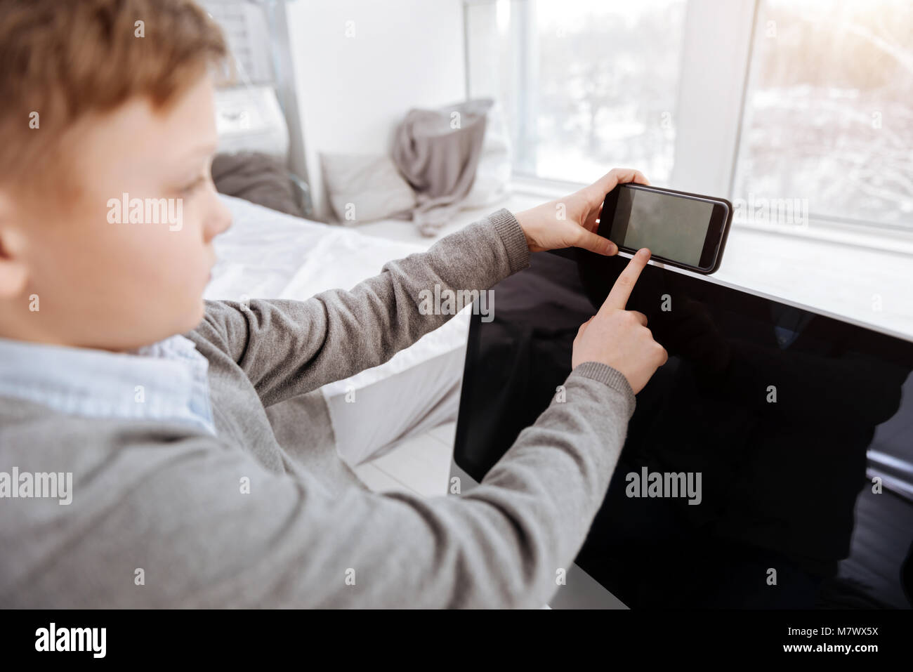 Pleasant nice boy using his gadget Stock Photo - Alamy