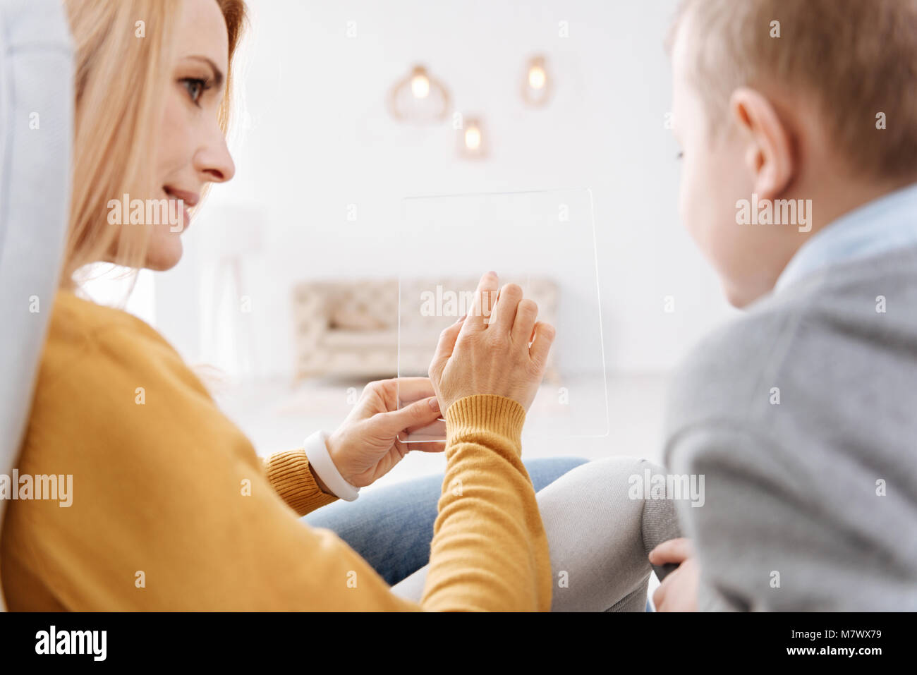 Nice pleasant woman holding a tablet Stock Photo - Alamy