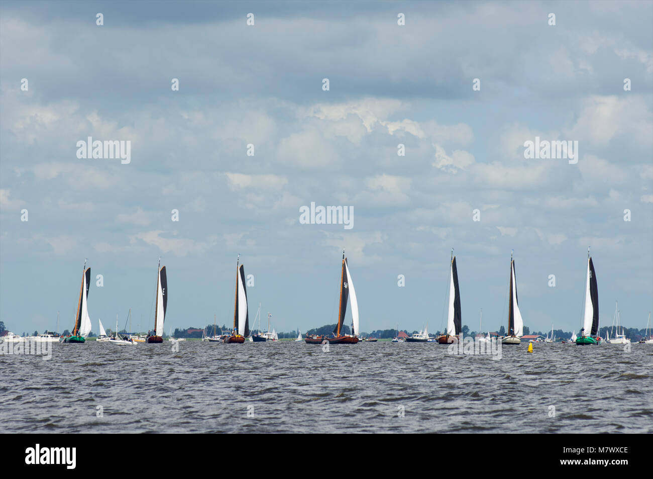 A traditional sailing race with classic Dutch wooden flat-bottemend ...