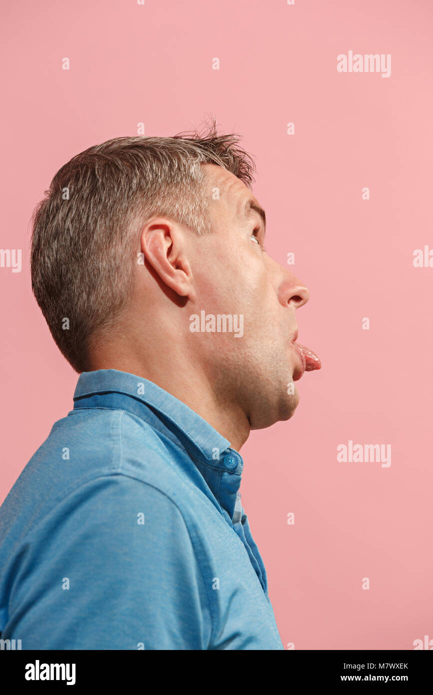 The squint eyed man with weird expression isolated on pink Stock Photo ...