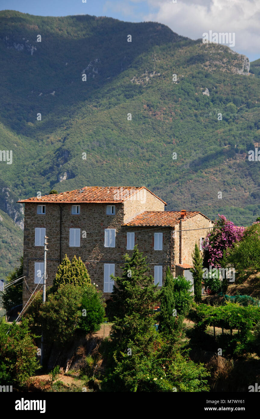 Italian stone house and lilac bouganville Stock Photo - Alamy