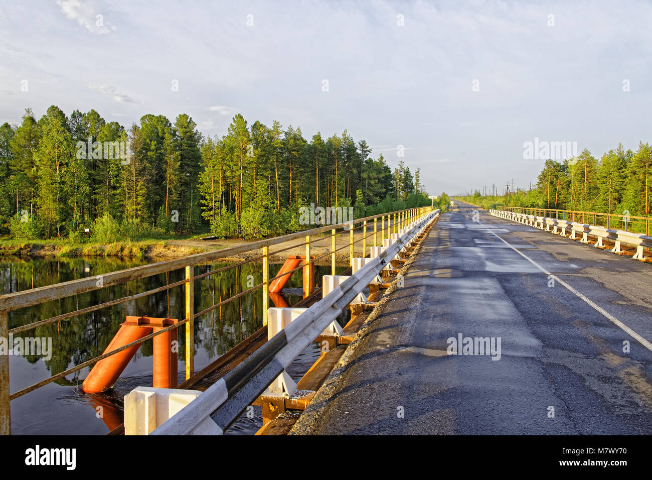 The bridge across the Siberian taiga and the river.Simple and reliable ...