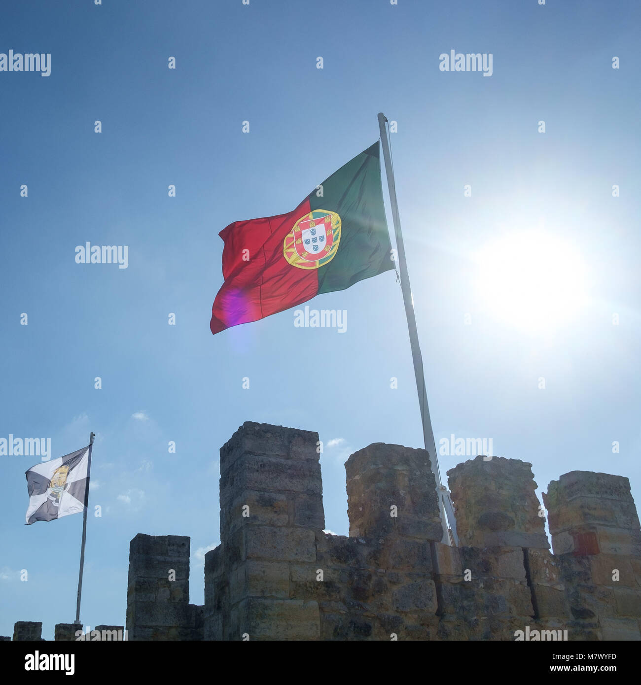 Portuguese flag streams over the battlements at Castelo de Sao Jorge ...