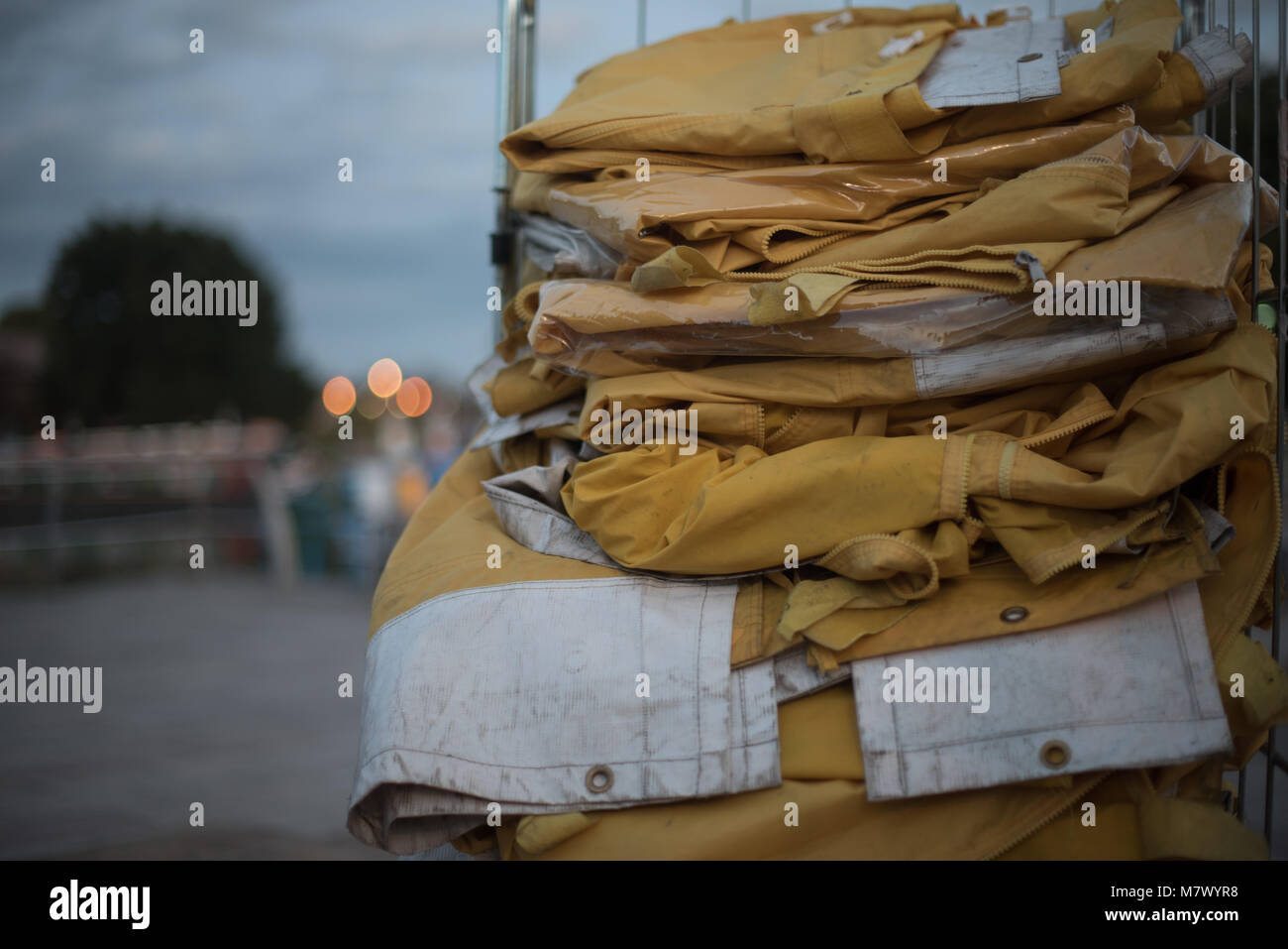 Tarpaulin market stall covers stored in a roll cage folded up and ready ...