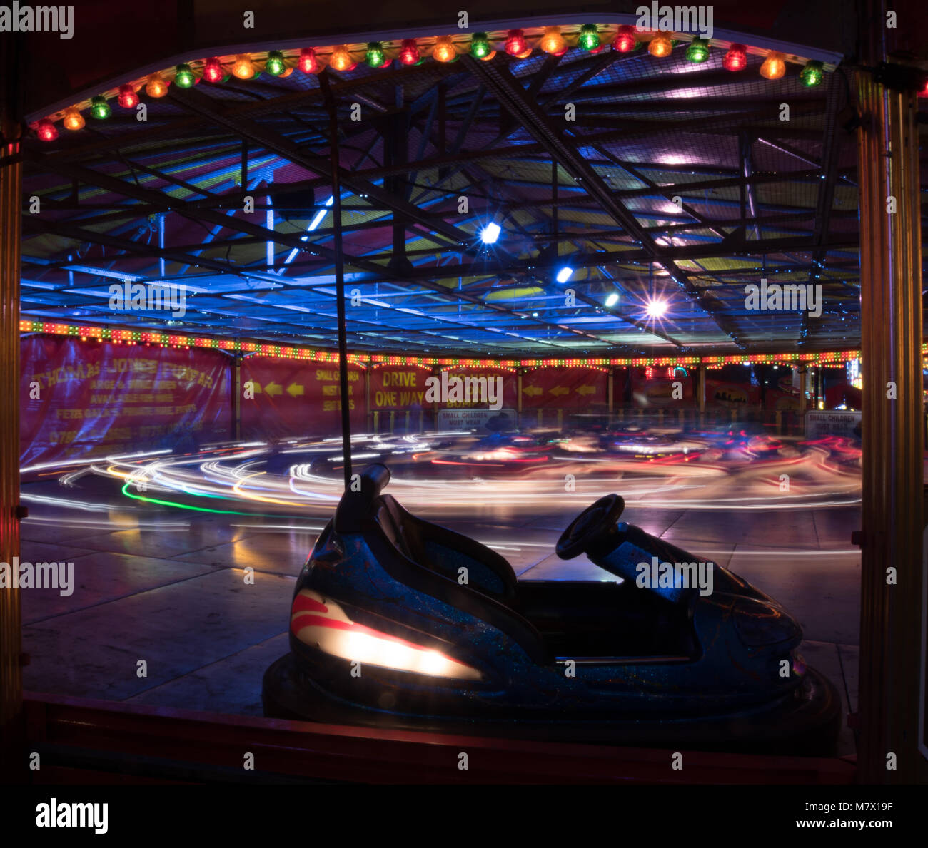 long exposure of bumper car dodgems ride at funfair gwith blurred ...