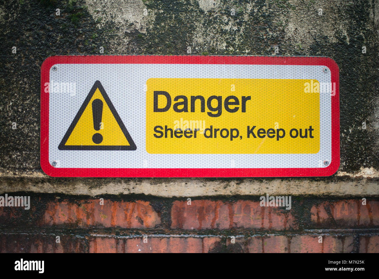 Red and yellow Danger Sheer Drop, Keep Out sign Stock Photo - Alamy