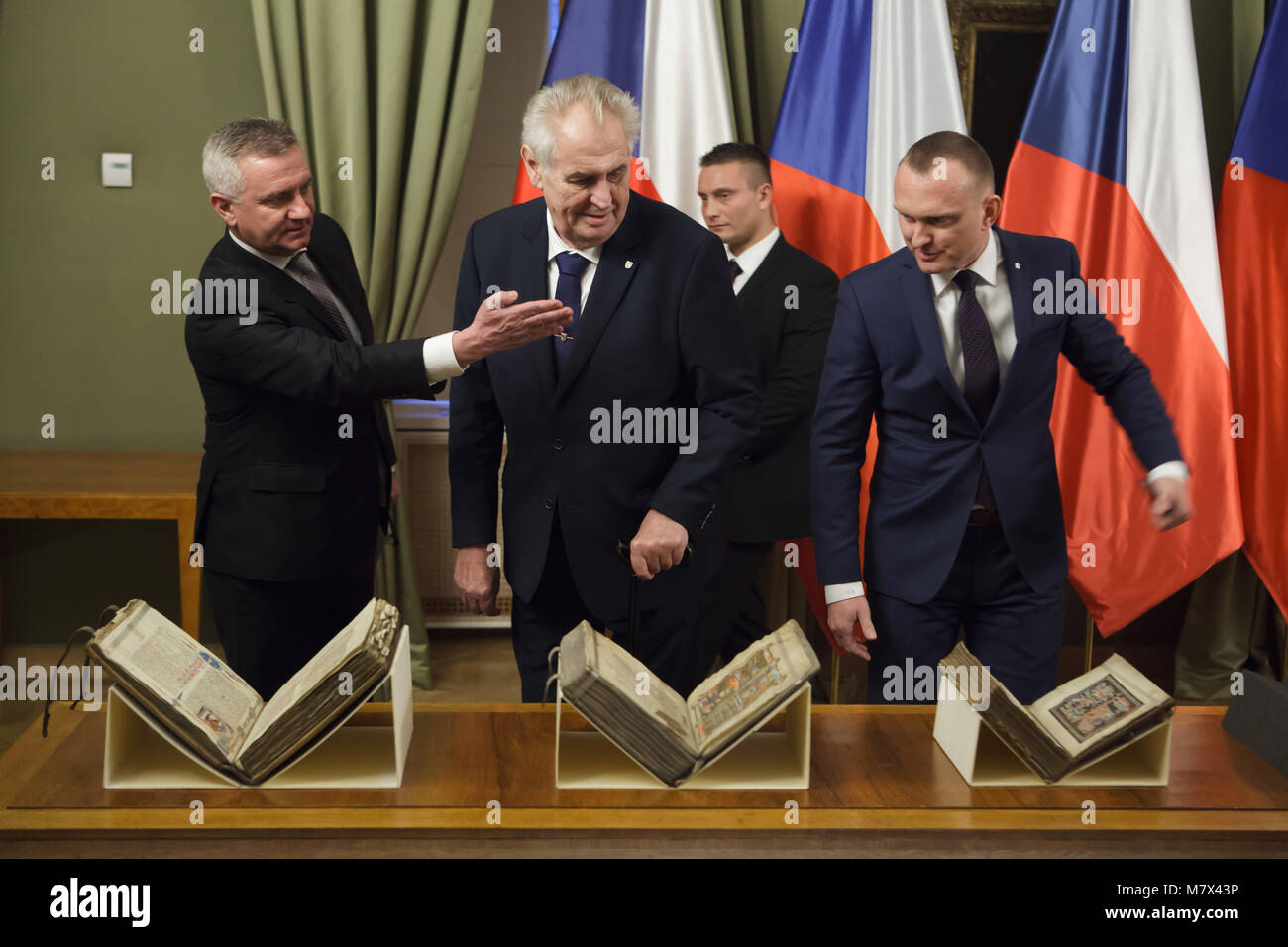 Czech President Miloš Zeman (C) observes the medieval illuminated ...
