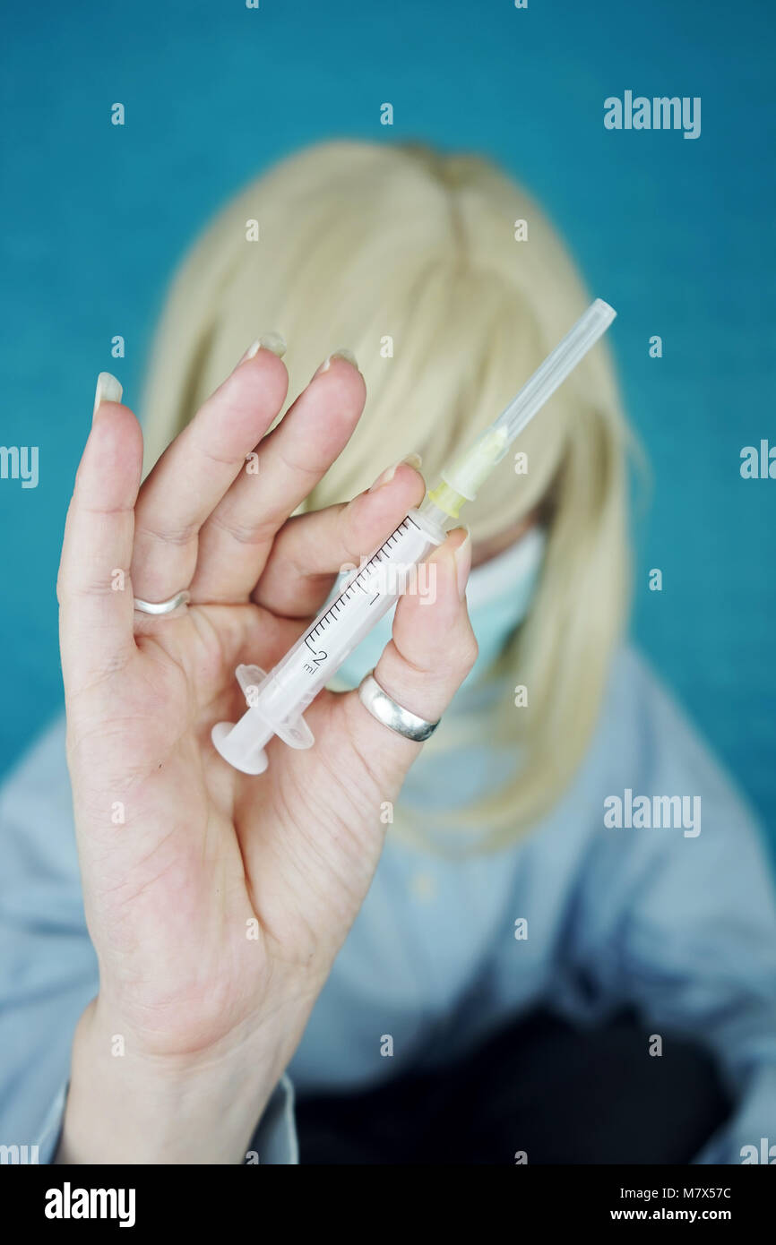 Young patient holding a syringe Stock Photo - Alamy