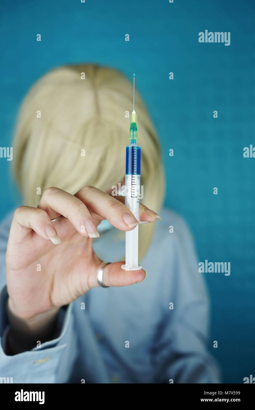 Young patient holding a syringe Stock Photo - Alamy