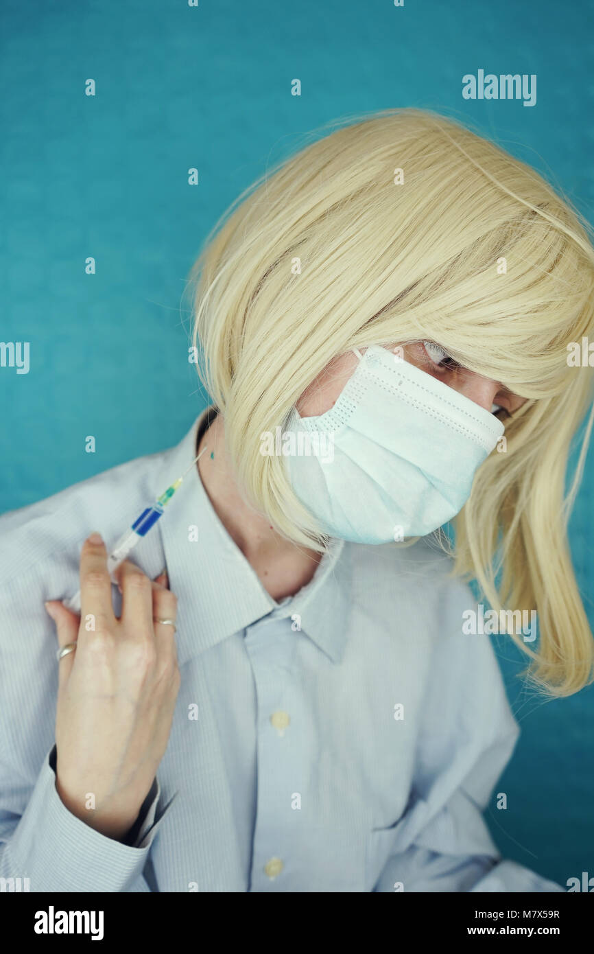 Young patient holding a syringe Stock Photo - Alamy