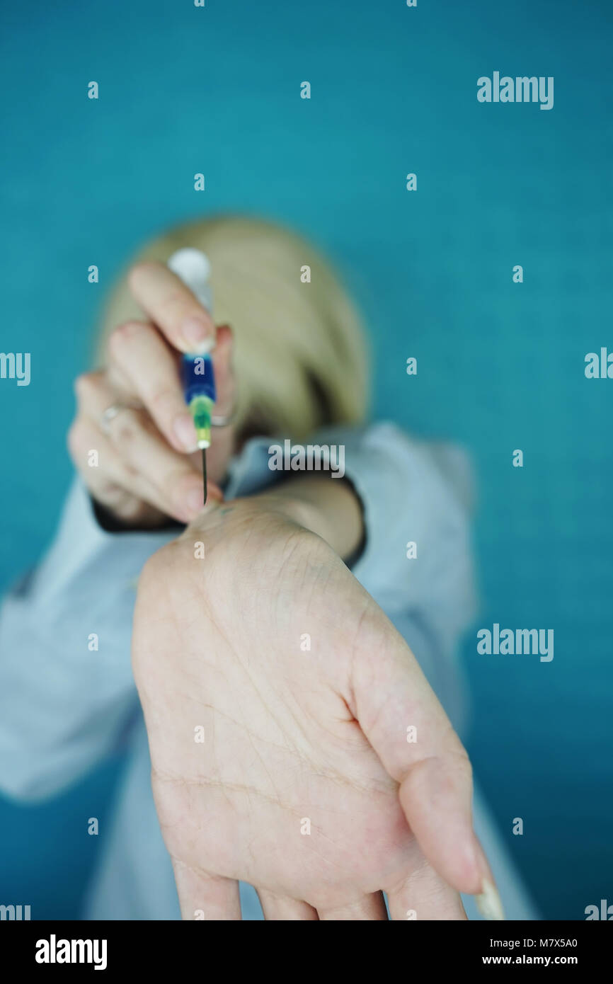 Young patient holding a syringe Stock Photo - Alamy