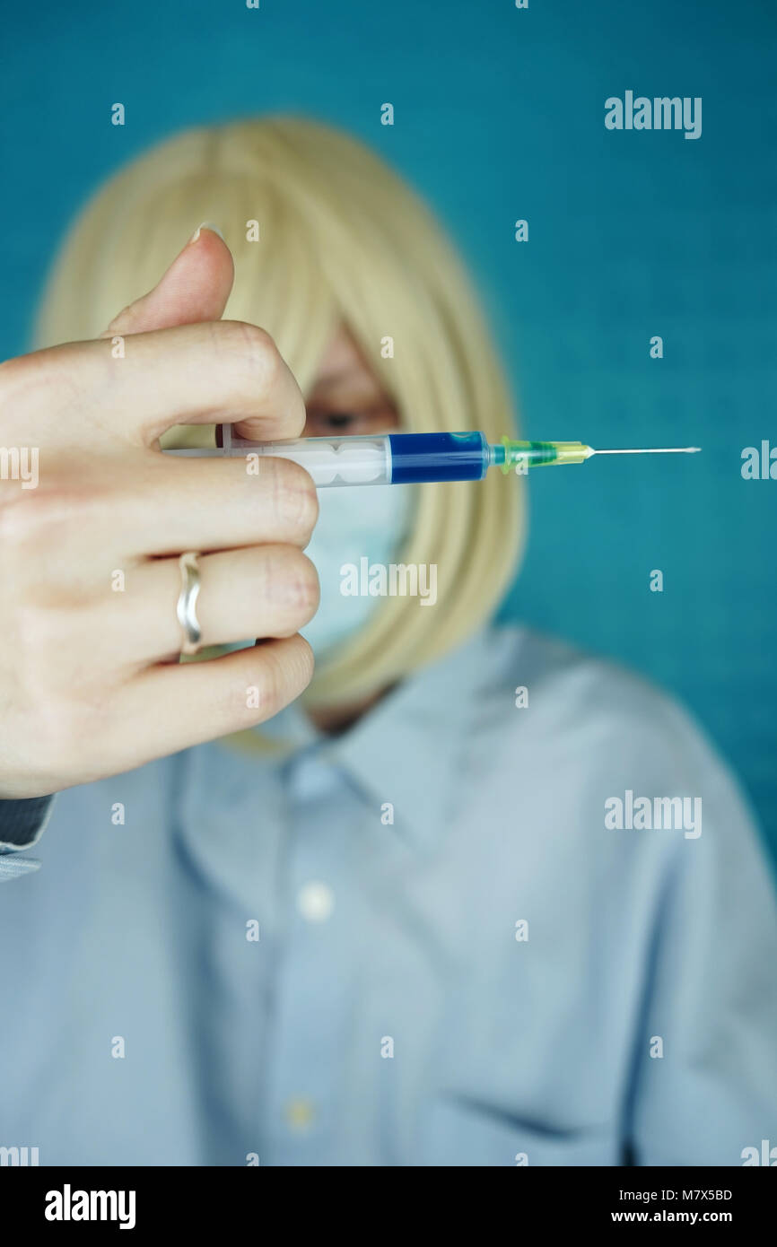 Young patient holding a syringe Stock Photo - Alamy