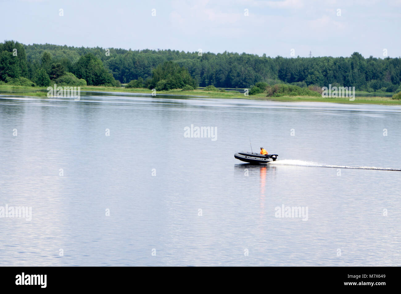 floats manages gray inflatable rubber boat with an outboard motor Stock ...