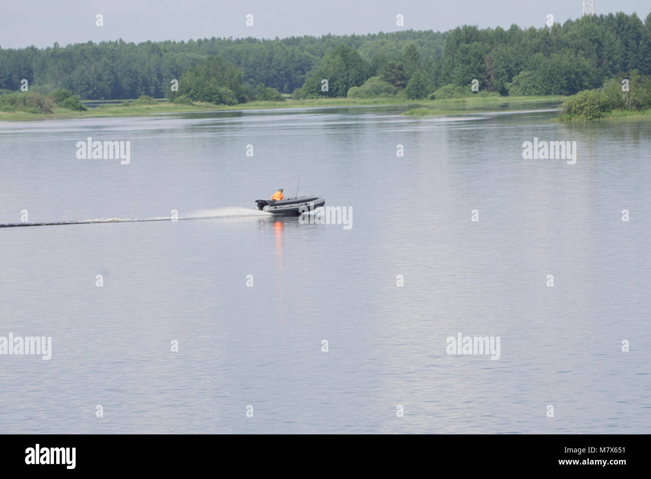 floats manages gray inflatable rubber boat with an outboard motor Stock ...