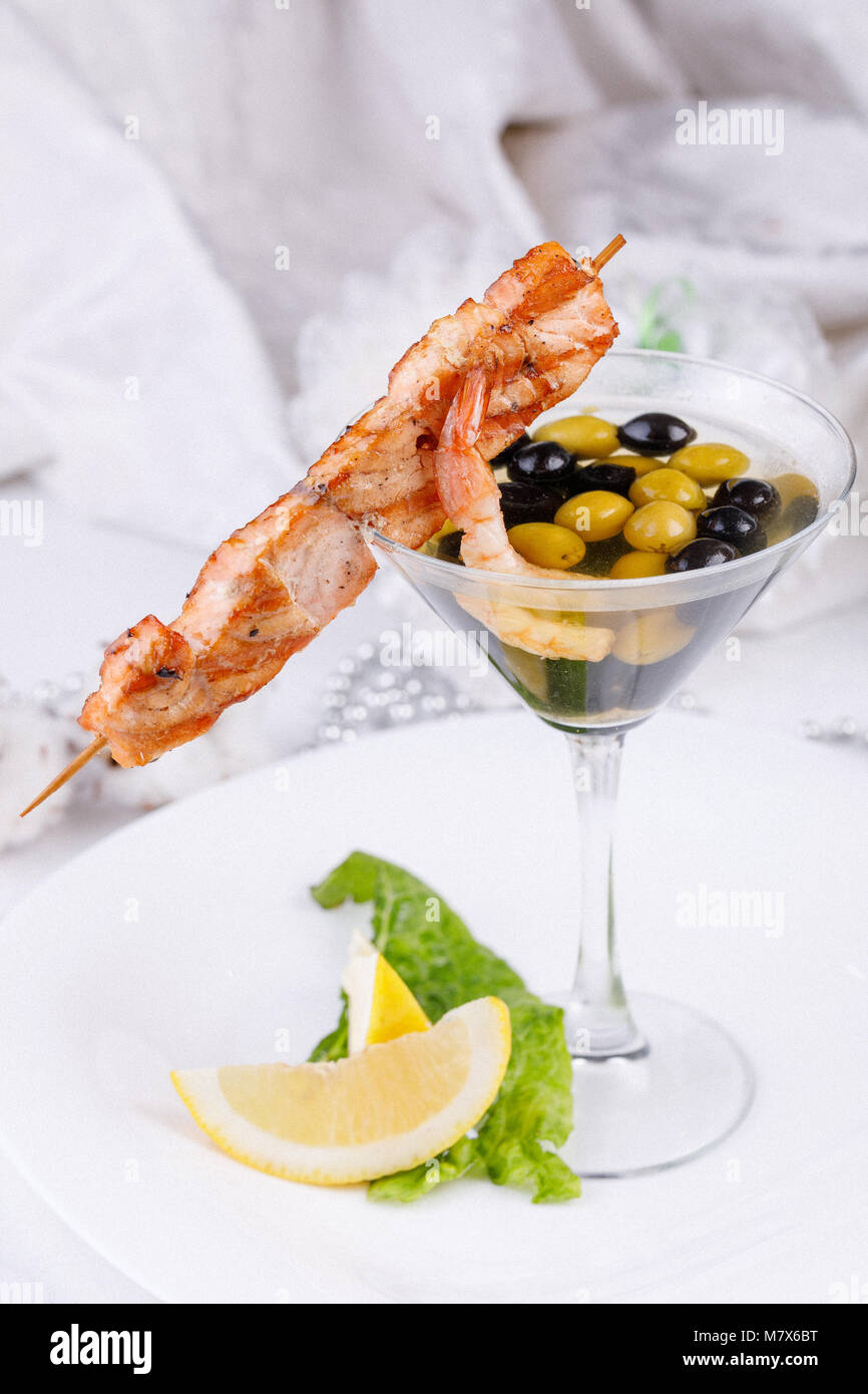Cold snack from shrimps and fish shish kebab with original serving of ...