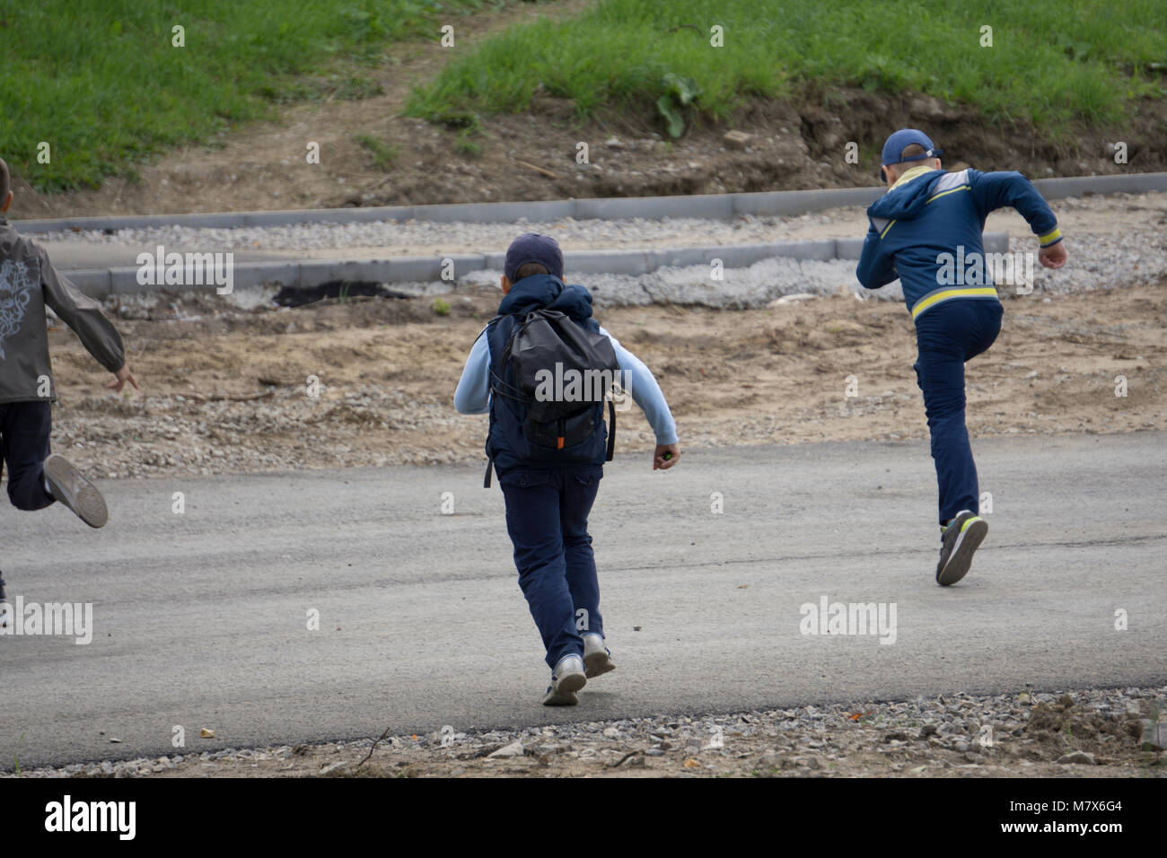 children run across the road not in the right place Stock Photo - Alamy
