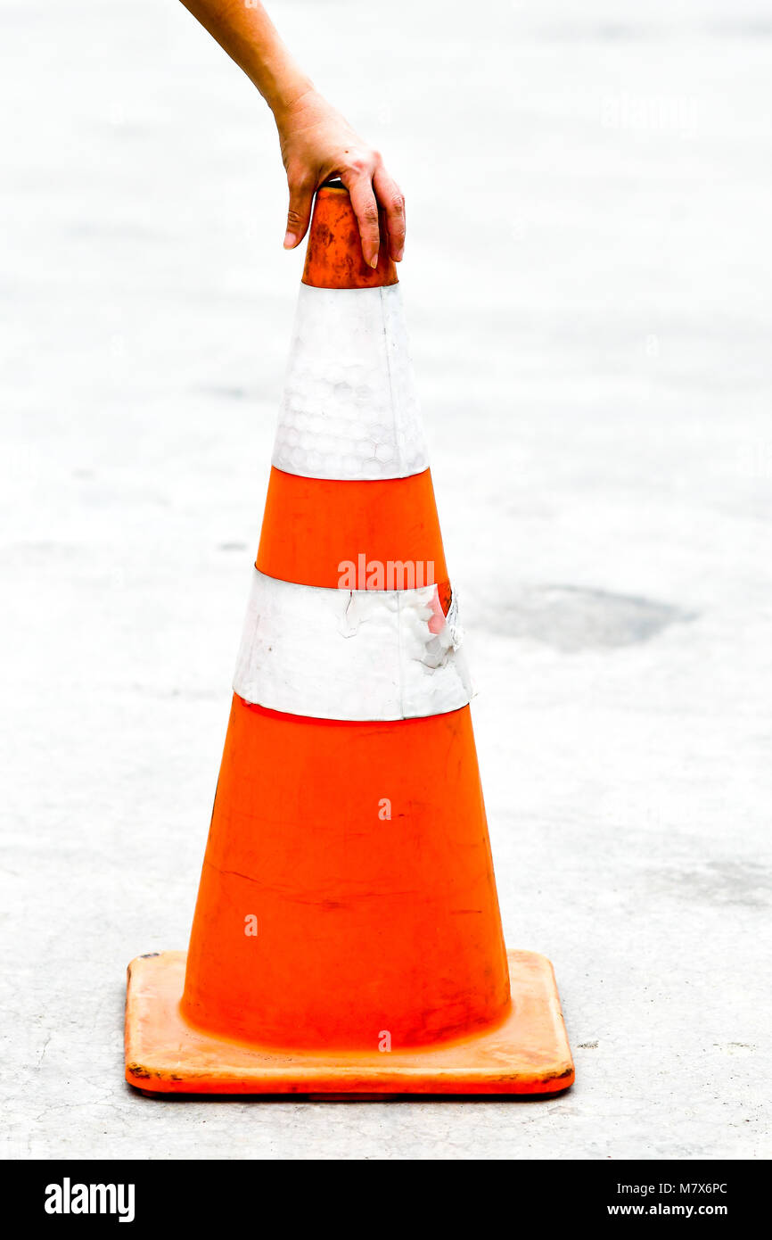 Placing an orange cone Stock Photo - Alamy