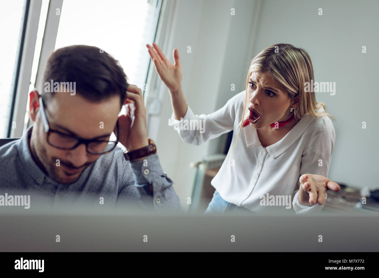 Young angry designers talking about project and arguing at the office ...