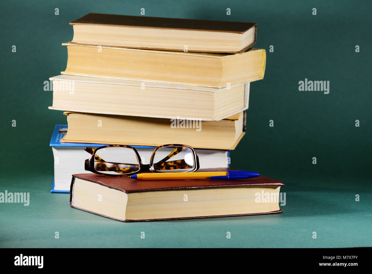 Still life - books with glasses.Arrangement is made on a green ...