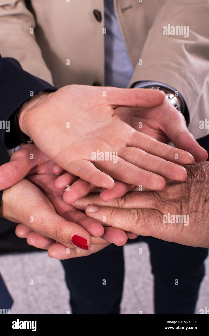 Group of diverse hands together joining hi-res stock photography and ...