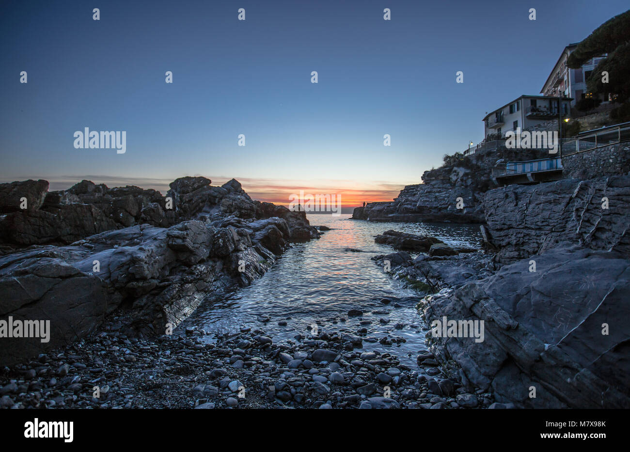 Sunset on the beach with rocks, mediterranean coast, Italy Stock Photo ...