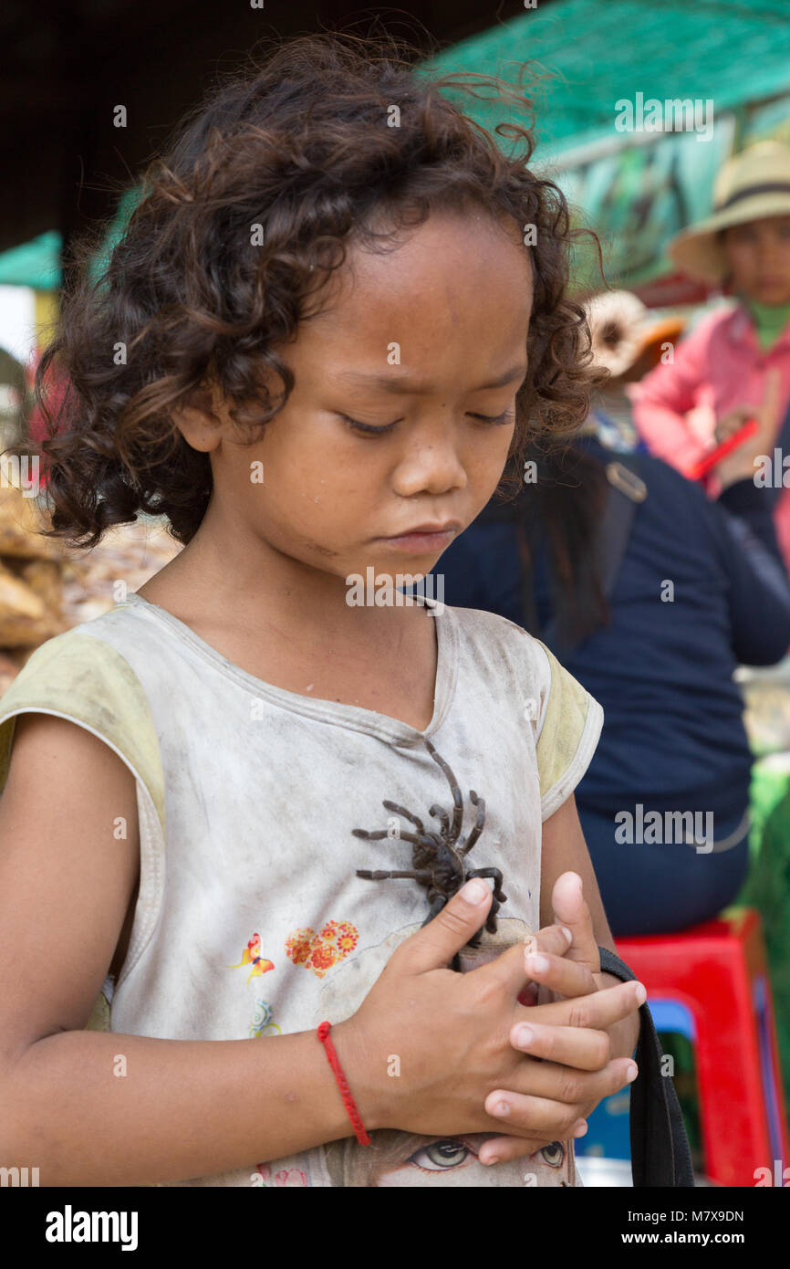 Cambodia child and a tarantula, Skuon insect market, or spider market ...