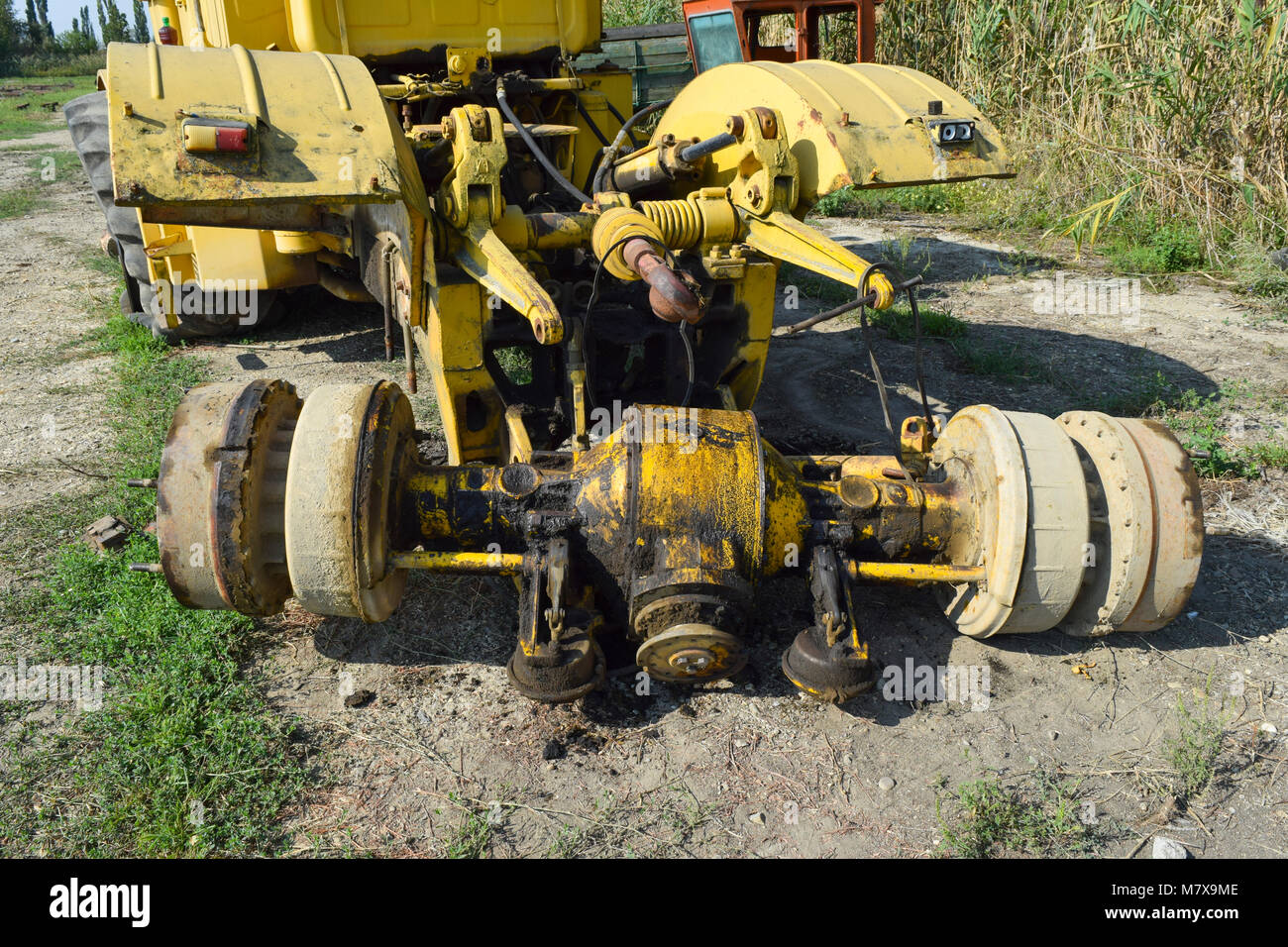Rear half of a large tractor. Disassembled tractor. Big yellow tractor ...