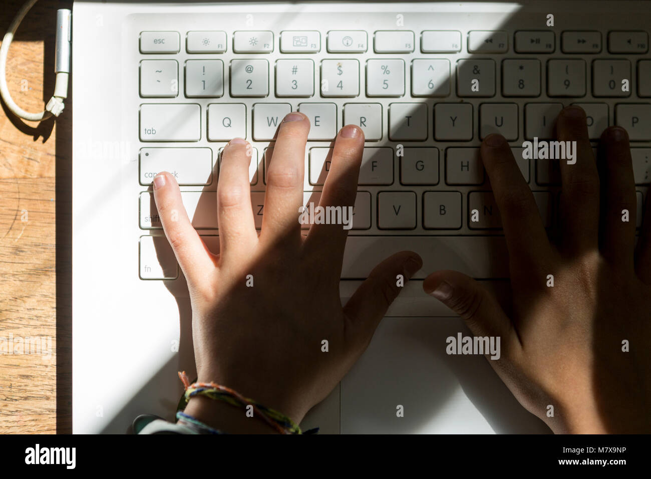 Little girl typing on keyboard of laptop computer Stock Photo - Alamy