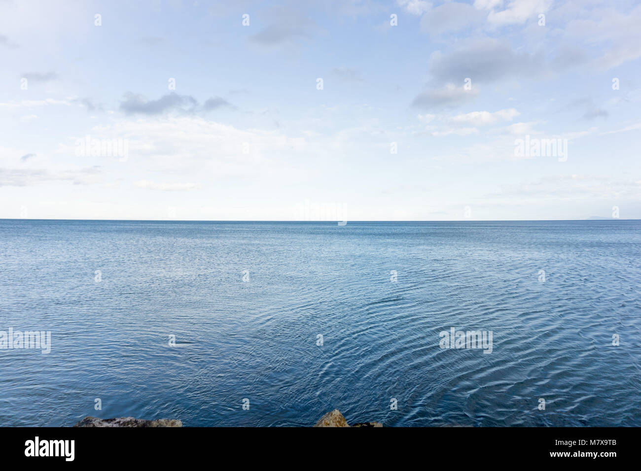 blue sea with blue sky with white clouds Stock Photo - Alamy
