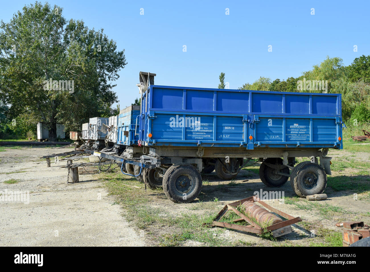 Russia, Temryuk - 15 July 2015: Trailers trucks for a tractor. The ...