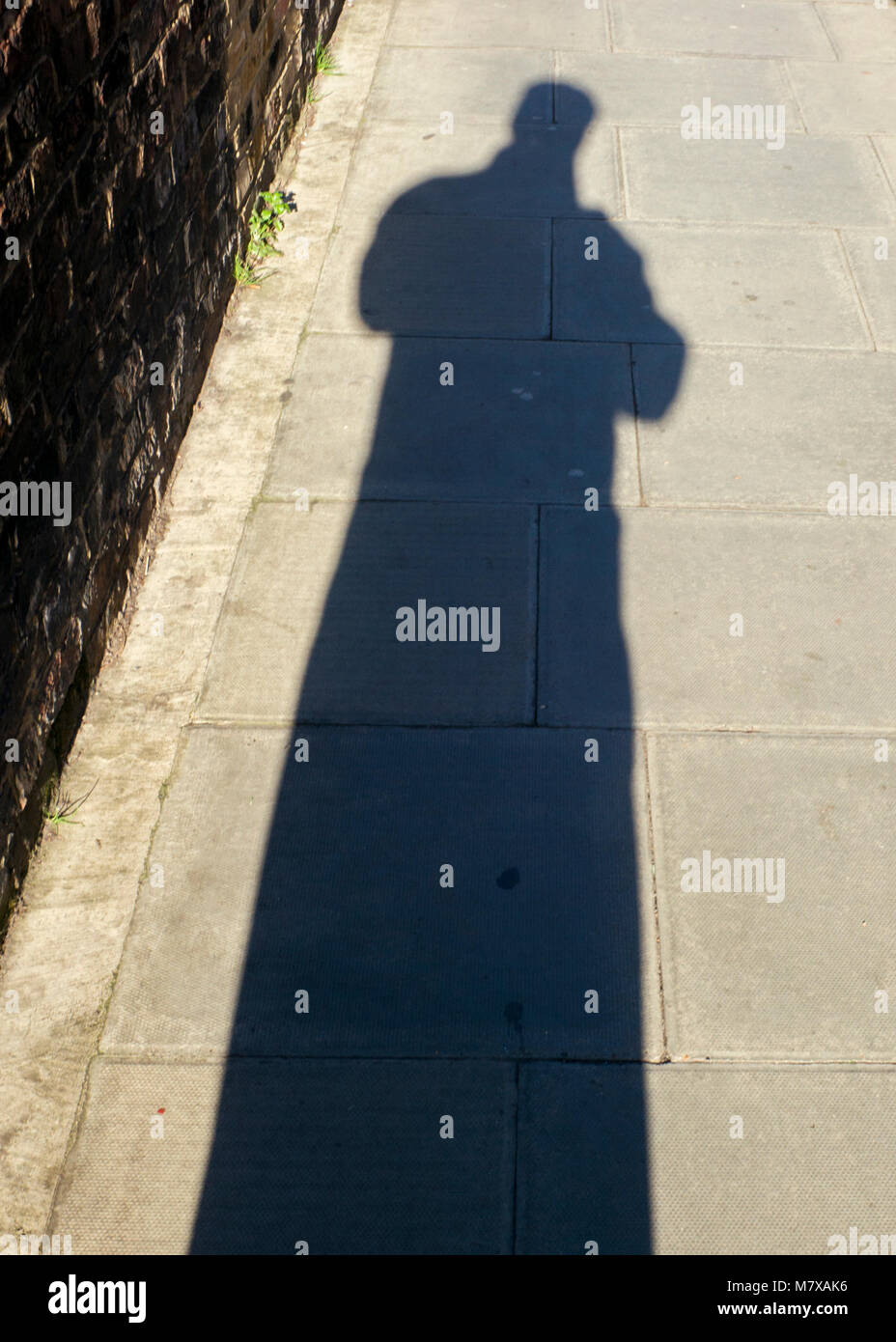 Man shadow following street hi-res stock photography and images - Alamy