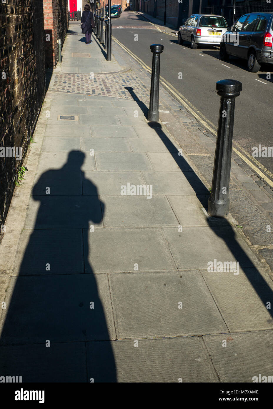Man shadow following street hi-res stock photography and images - Alamy