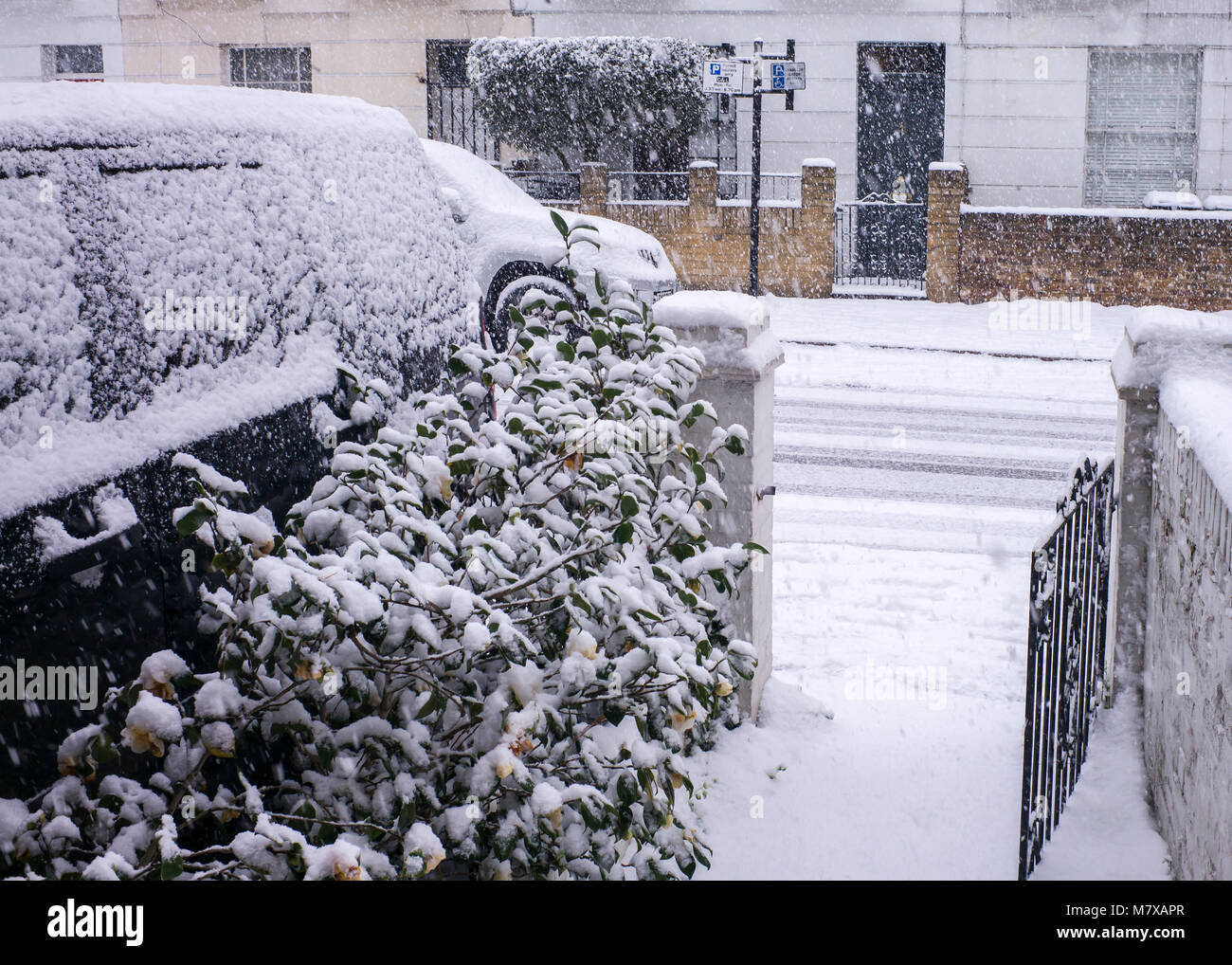 London in snow covering path gate and street hi-res stock photography ...