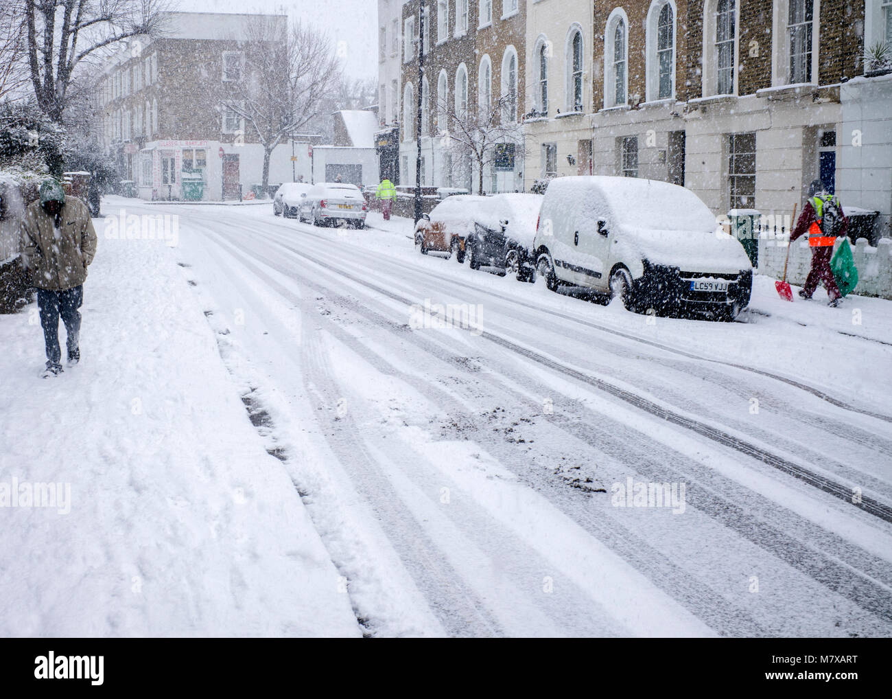 london in snow covering path gate and street Stock Photo - Alamy