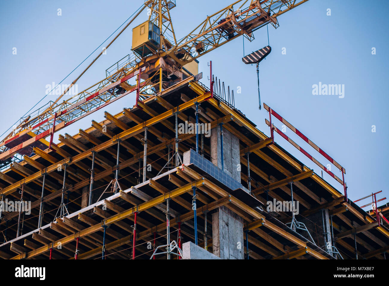 Crane and building construction site on background of sky. Industrial ...