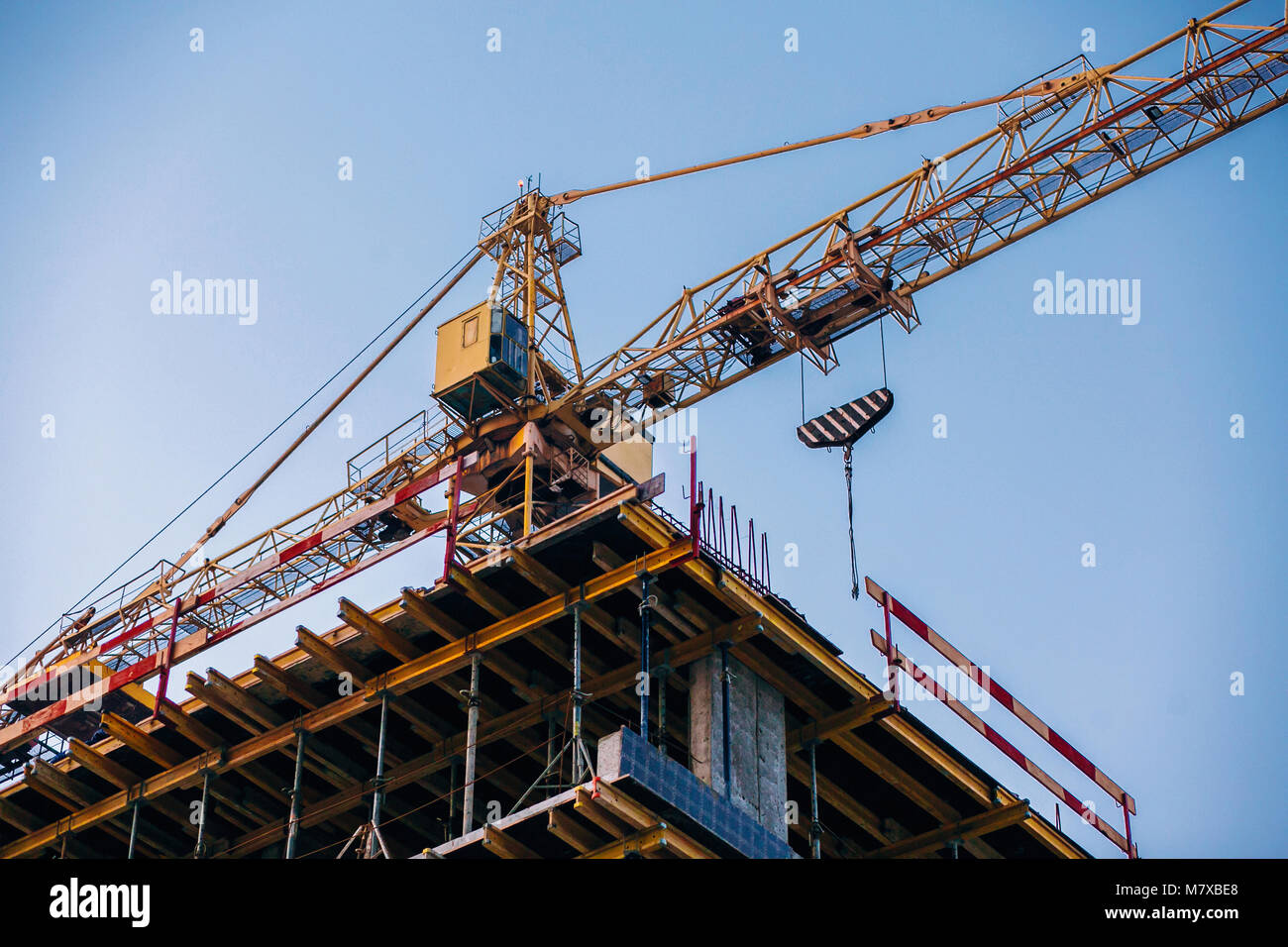 Crane and building construction site on background of sky. Industrial ...