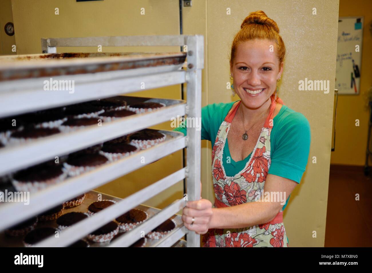 Woman baker working at her small commercial bakery kitchen in USA Stock ...