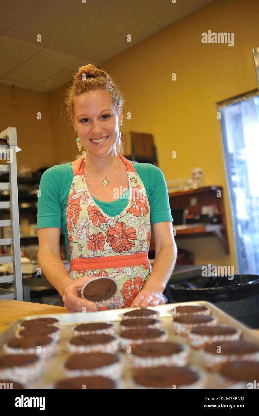 Woman baker working at her small commercial bakery kitchen in USA Stock ...