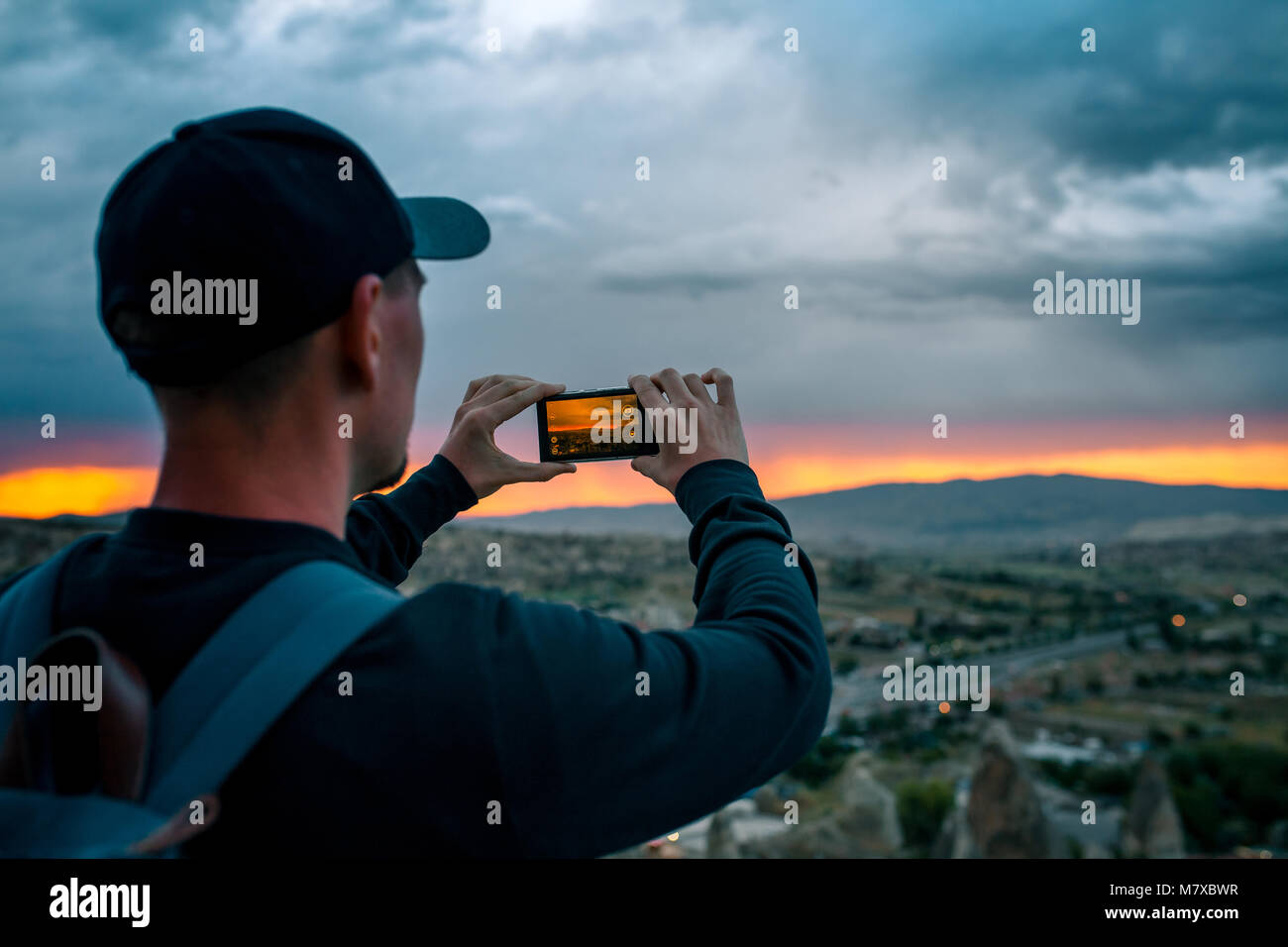 Tourist from a high point looking at the sunset over the city of Goreme ...
