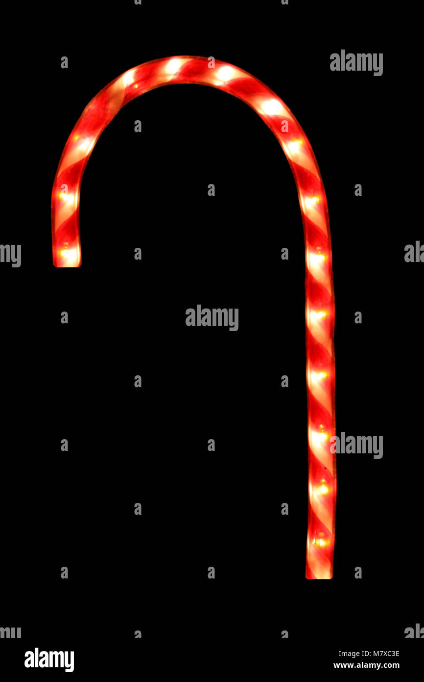 A Candy Cane light on black background Stock Photo - Alamy