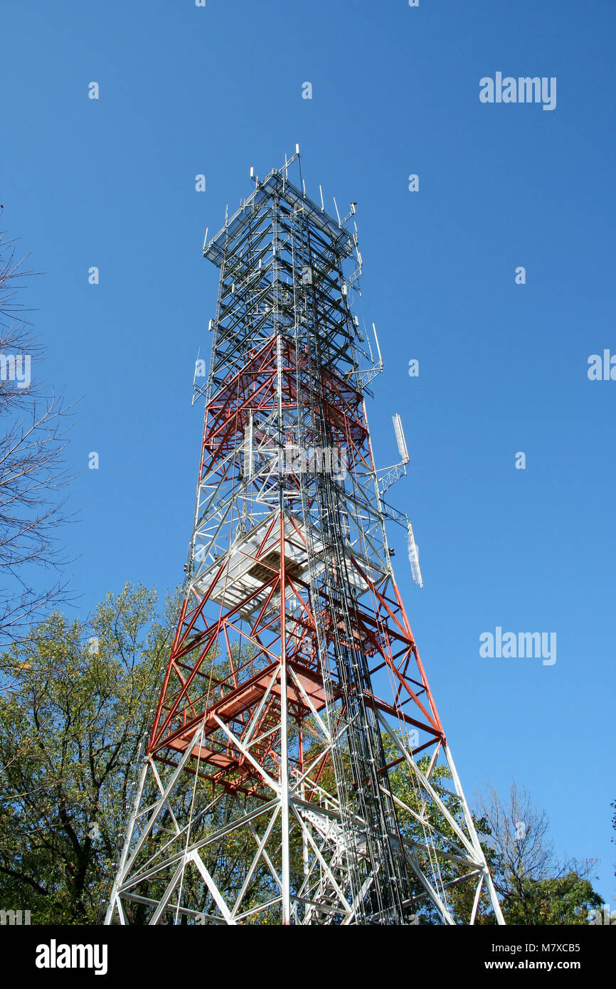 A Radio antenna tower against a blue sky Stock Photo - Alamy