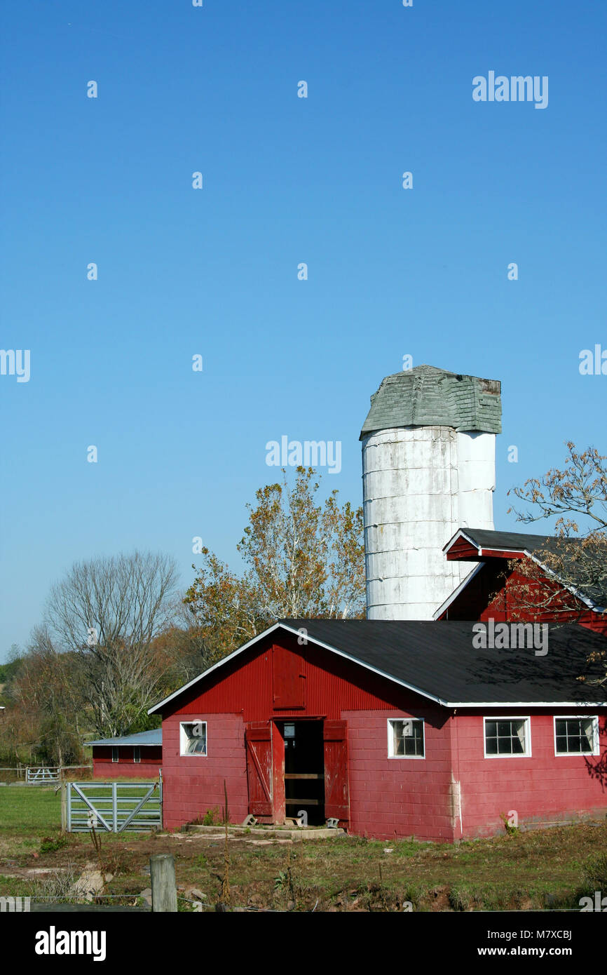 A Red Barn and silo against blue sky Stock Photo - Alamy